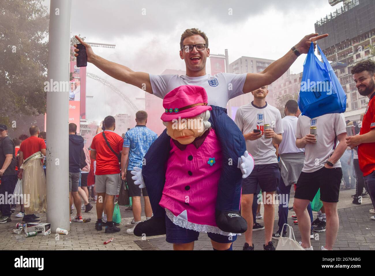 London, UK. 11th July, 2021. An England football fan wears a costume of ...