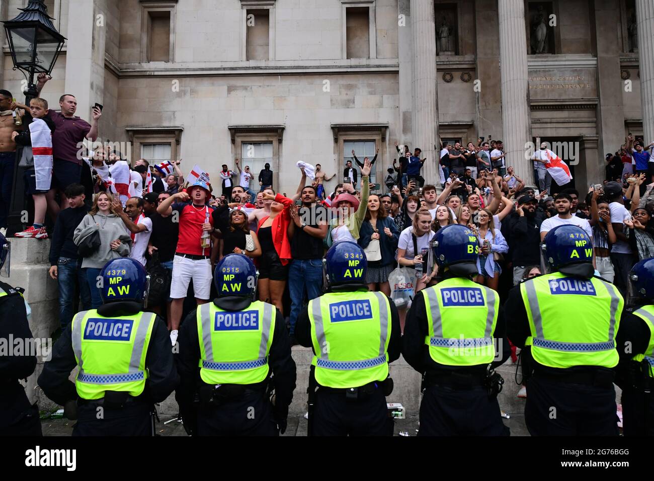 Metropolitan police officers observe England fans on the steps of the ...