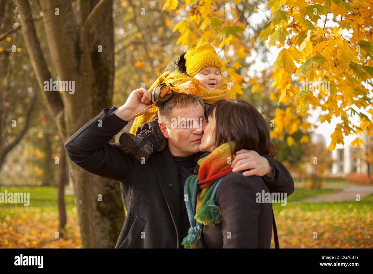 Happy loving family cuddling in fall park outdoors. Family love, care ...