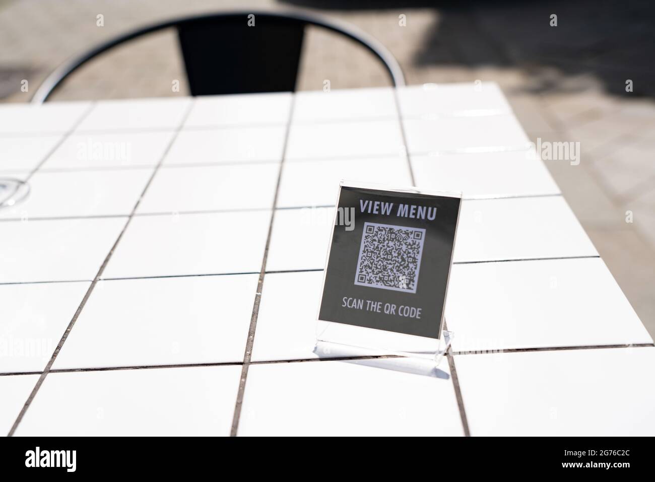 View menu and Scan the QR code sign on the table in the cafe Stock ...