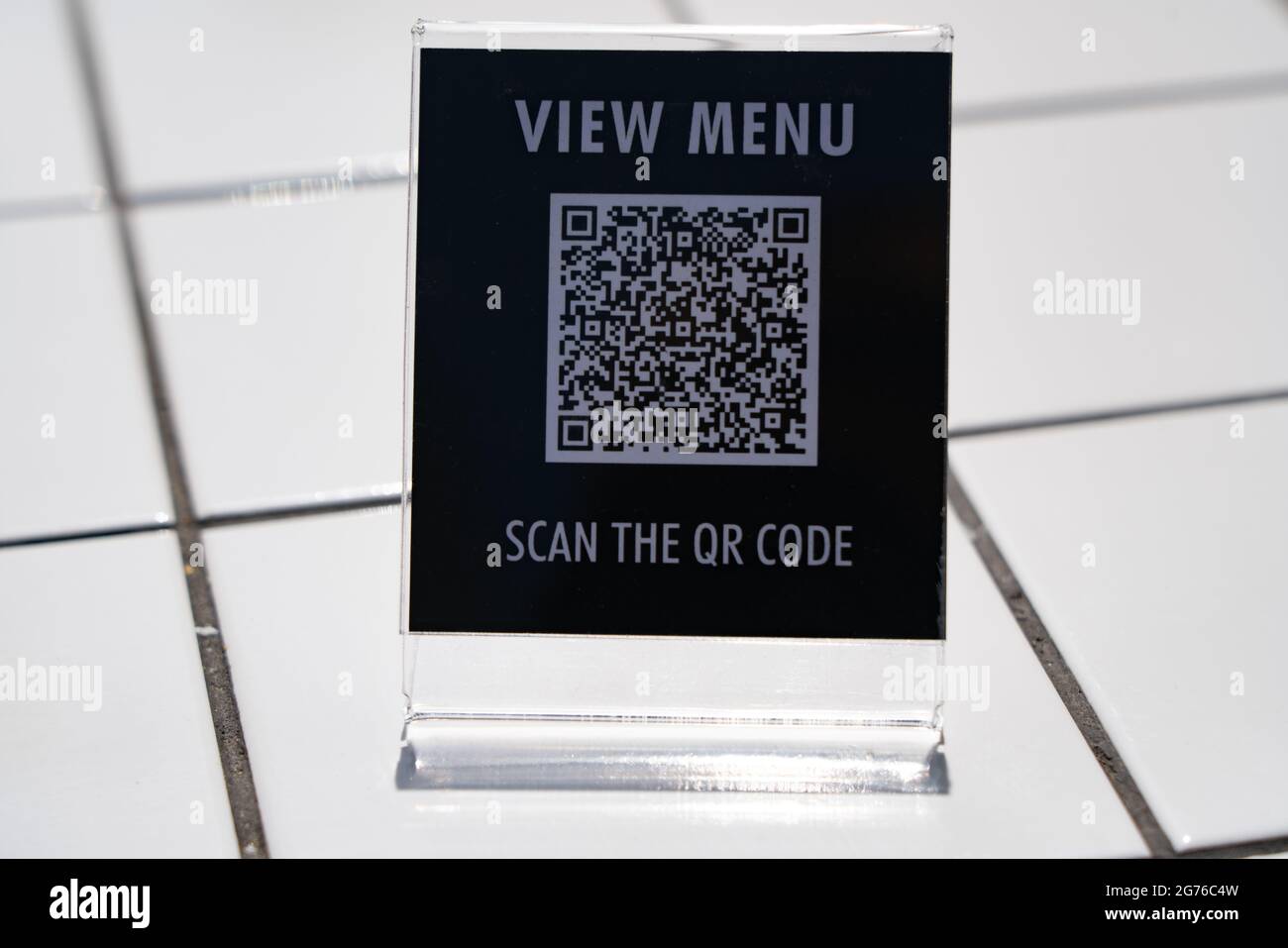 View menu and Scan the QR code sign on the table in the cafe Stock ...