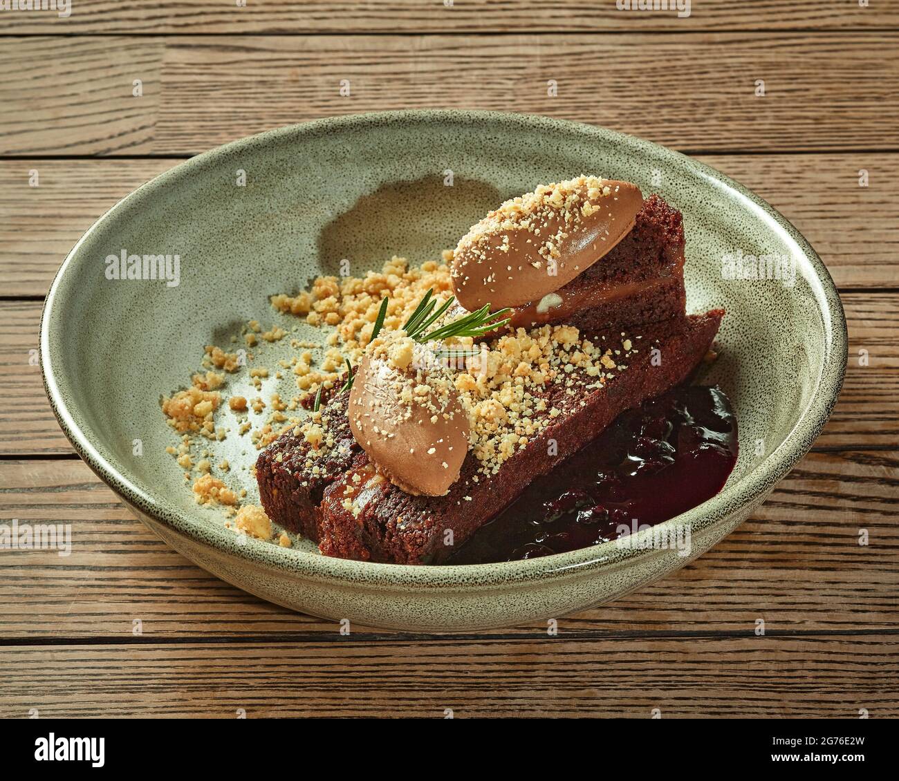 Chocolate cake with cream mousse, berry compote and nut crumbs Stock ...