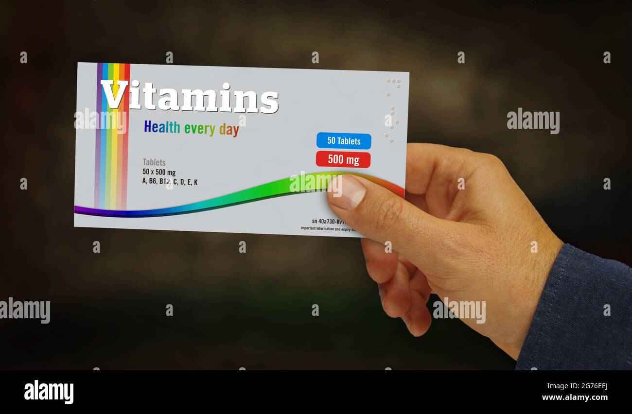 Vitamin tablets box in hand. Health supplement pills pack factory ...