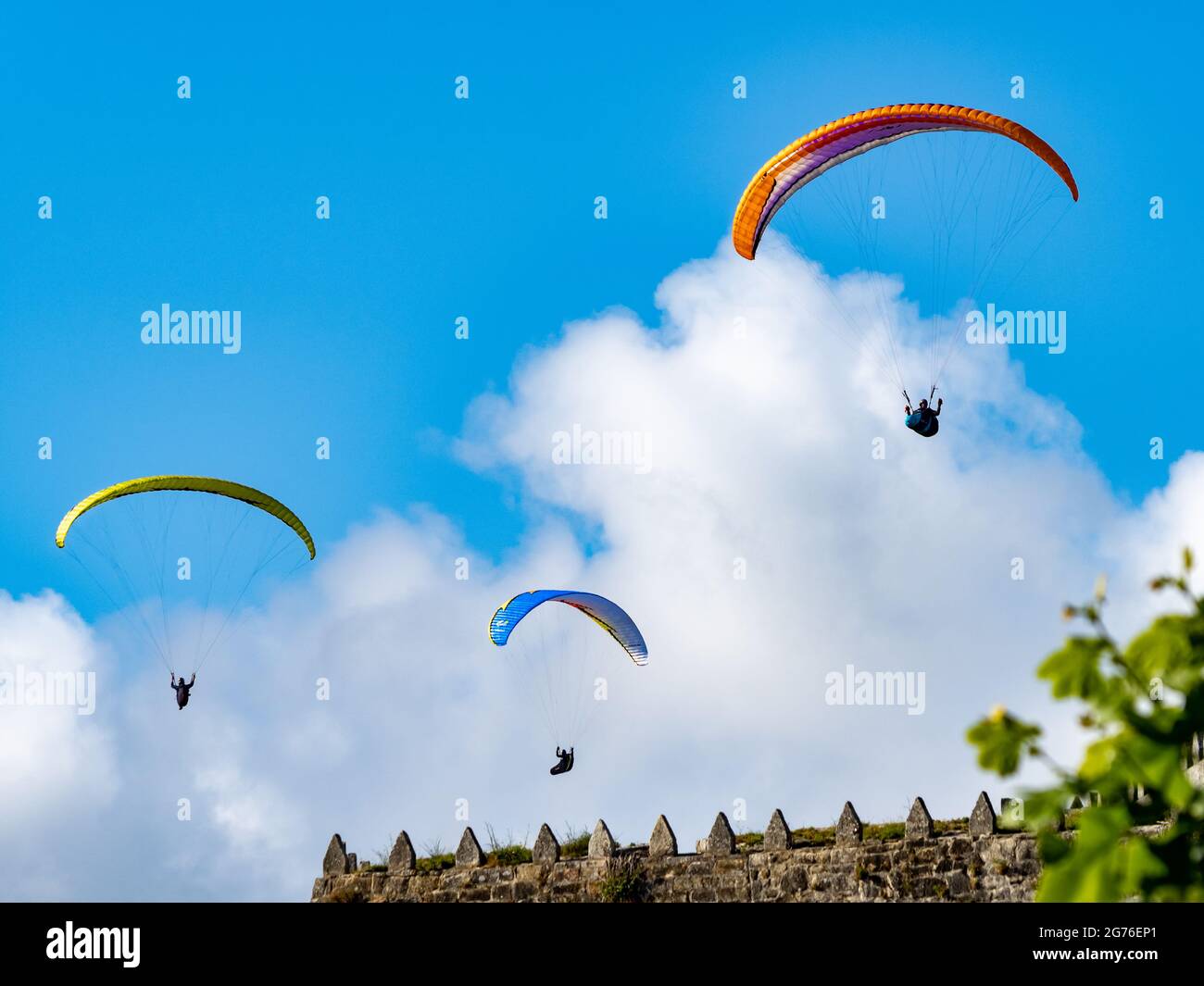 A group of people paragliding with beautiful clouds in the background ...