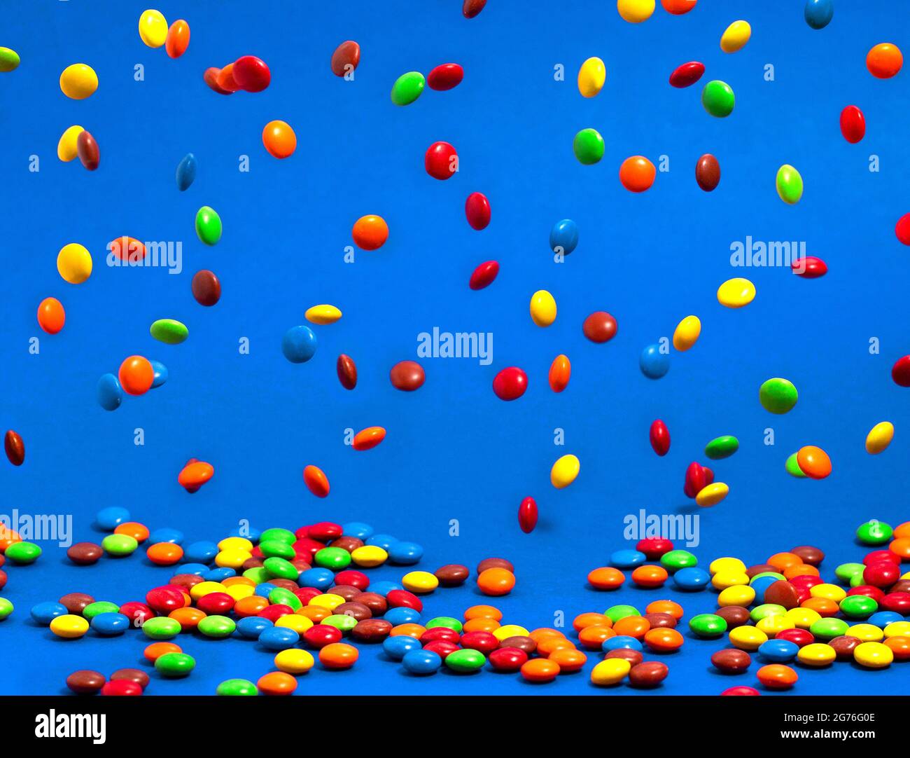 Rainbow Colored Candy Coated Chocolate Buttons Falling into a Pile ...