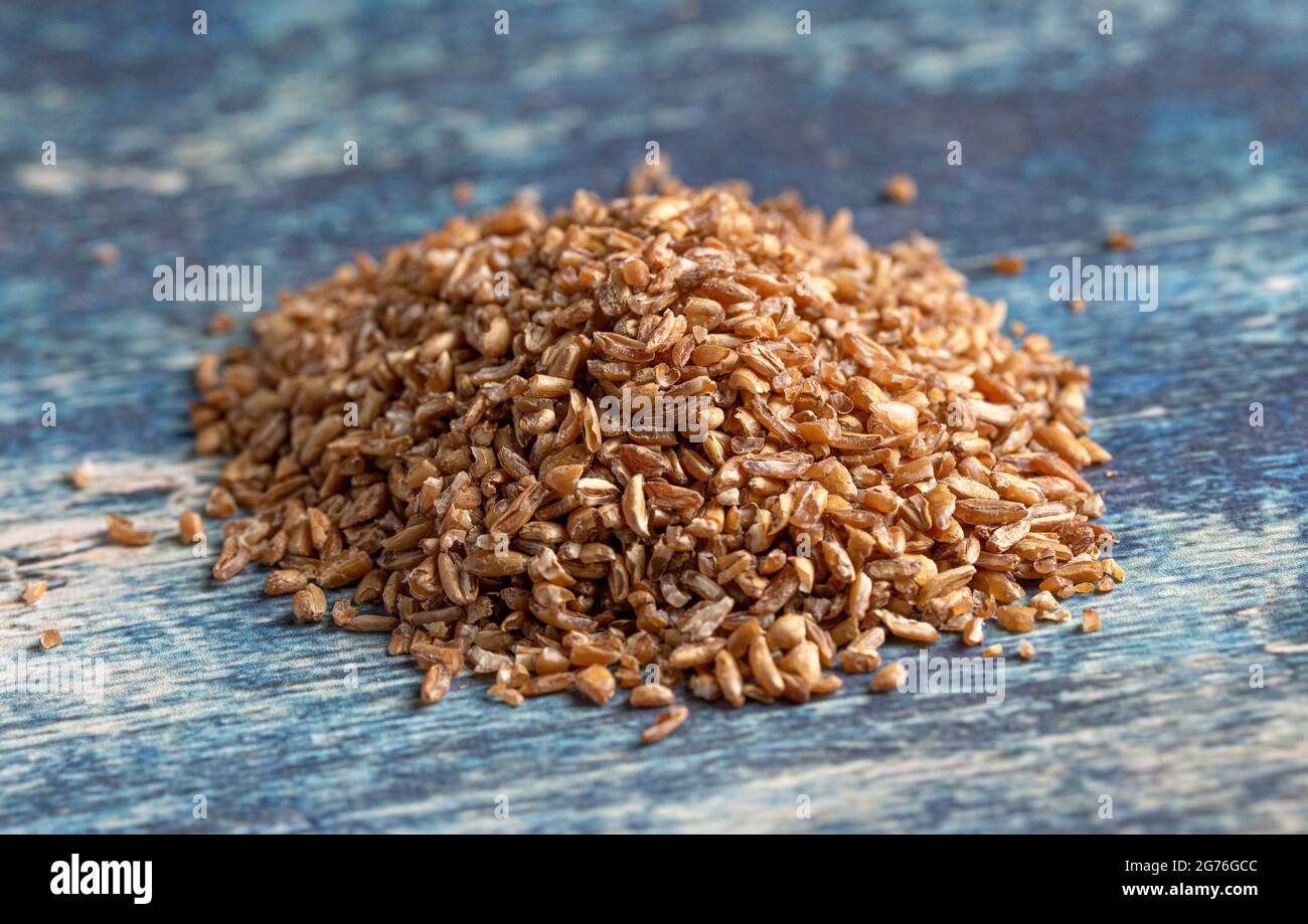 Pile of Bulgur Wheat on a Rustic Blue Table Stock Photo - Alamy