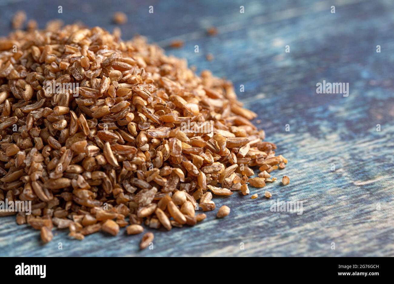 Pile of Bulgur Wheat on a Rustic Blue Table Stock Photo - Alamy