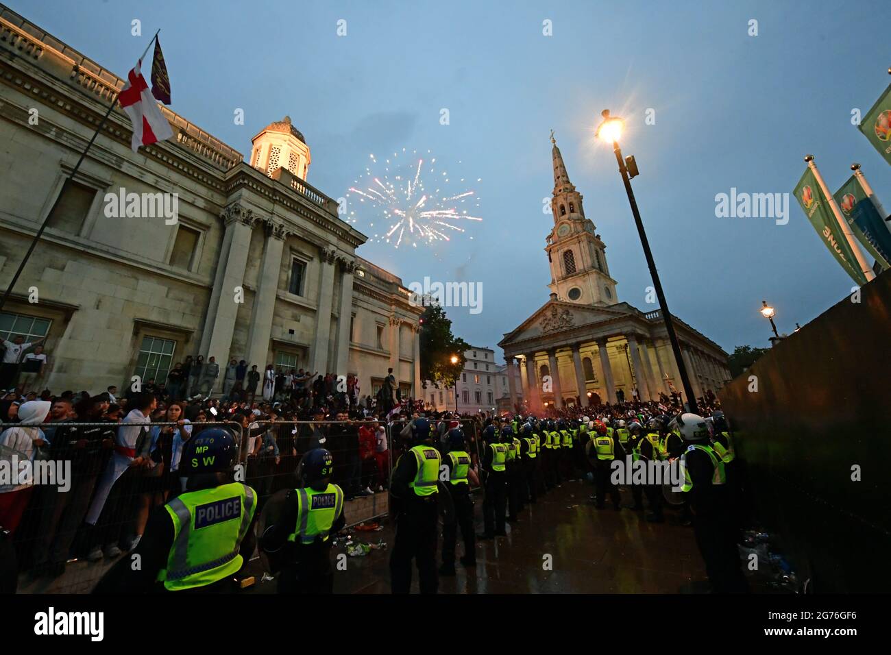 Fireworks are set off whilst police officers observe England fans on ...