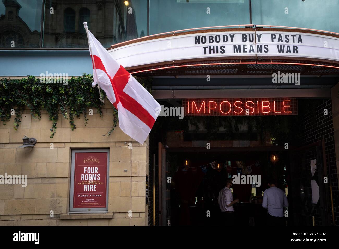 London, UK. 11th July, 2021. An England flag hang at the entrance of a ...