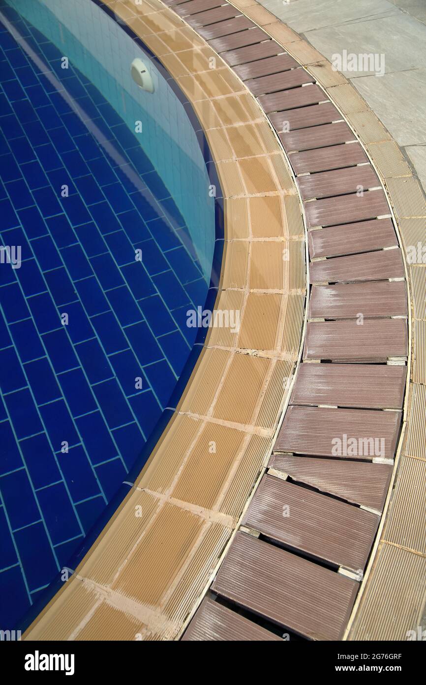 Blue clear clean water in swimming pool, tails around, arche of tails ...