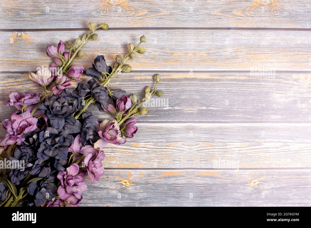 A Background with Copy Space and Purple Flowers on a Rustic Wood Table ...