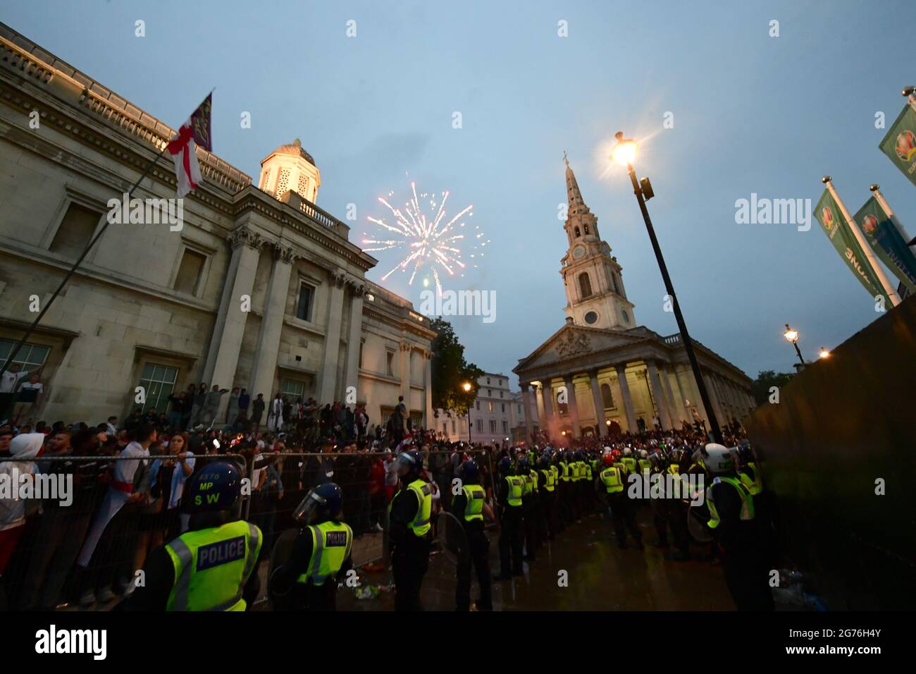 Fireworks are set off whilst police officers observe England fans on ...