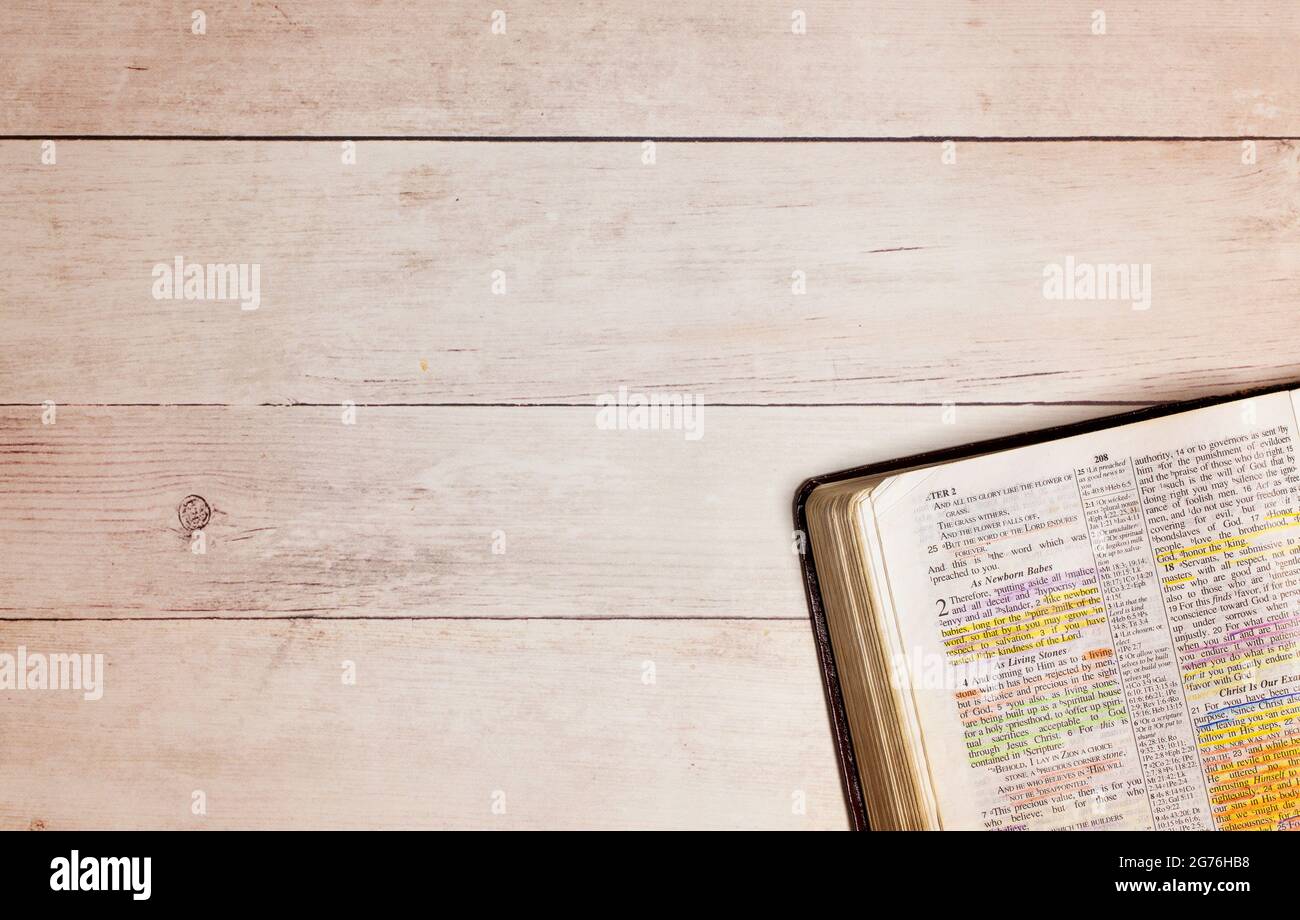 A Used and Highlighted Bible Open on a White Wood Table Stock Photo - Alamy