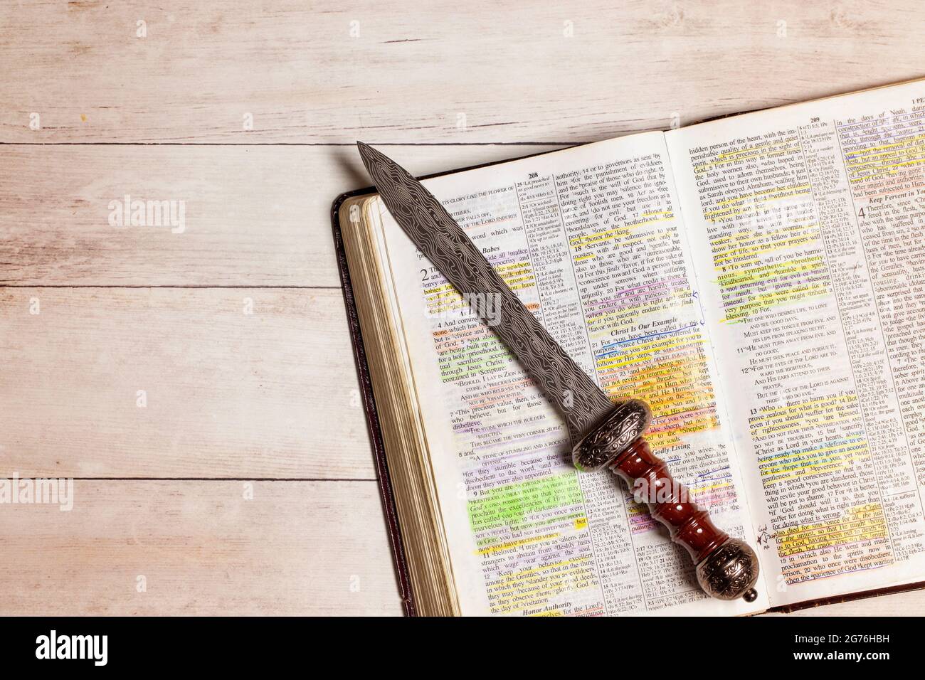 A Bible with a Sword on a Bright White Wooden Table Stock Photo - Alamy