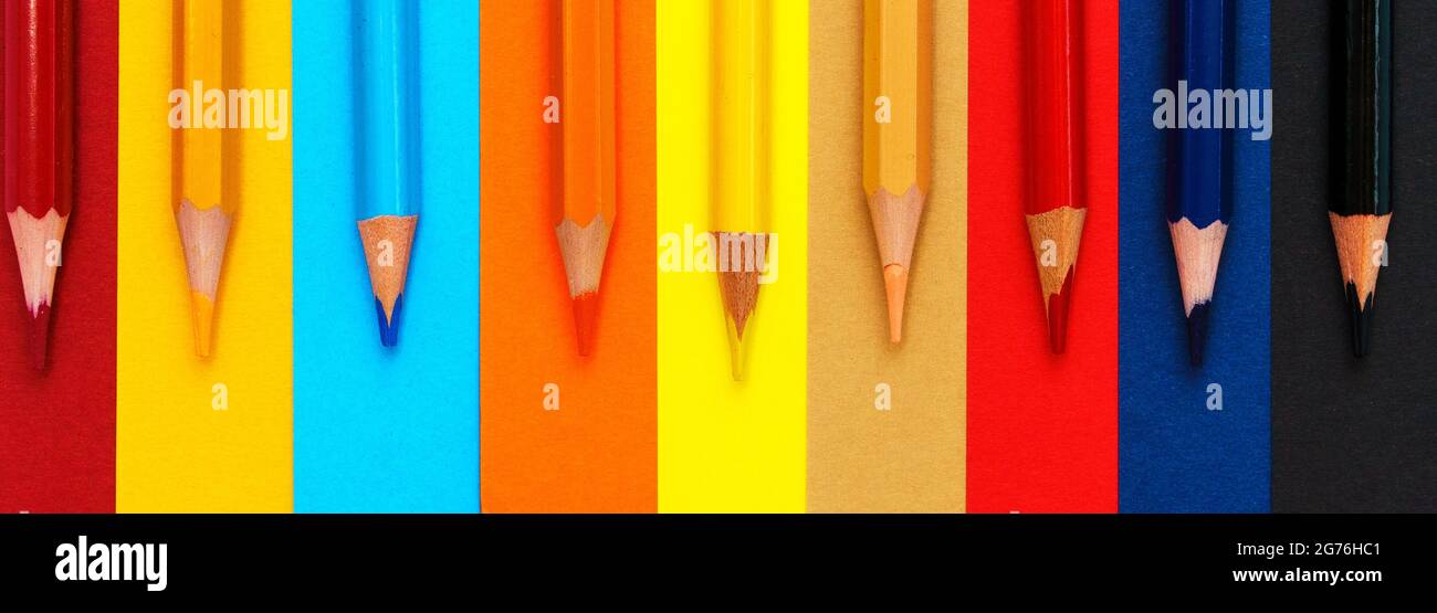 Colored pencils on a multi-colored background. Many pencils of ...