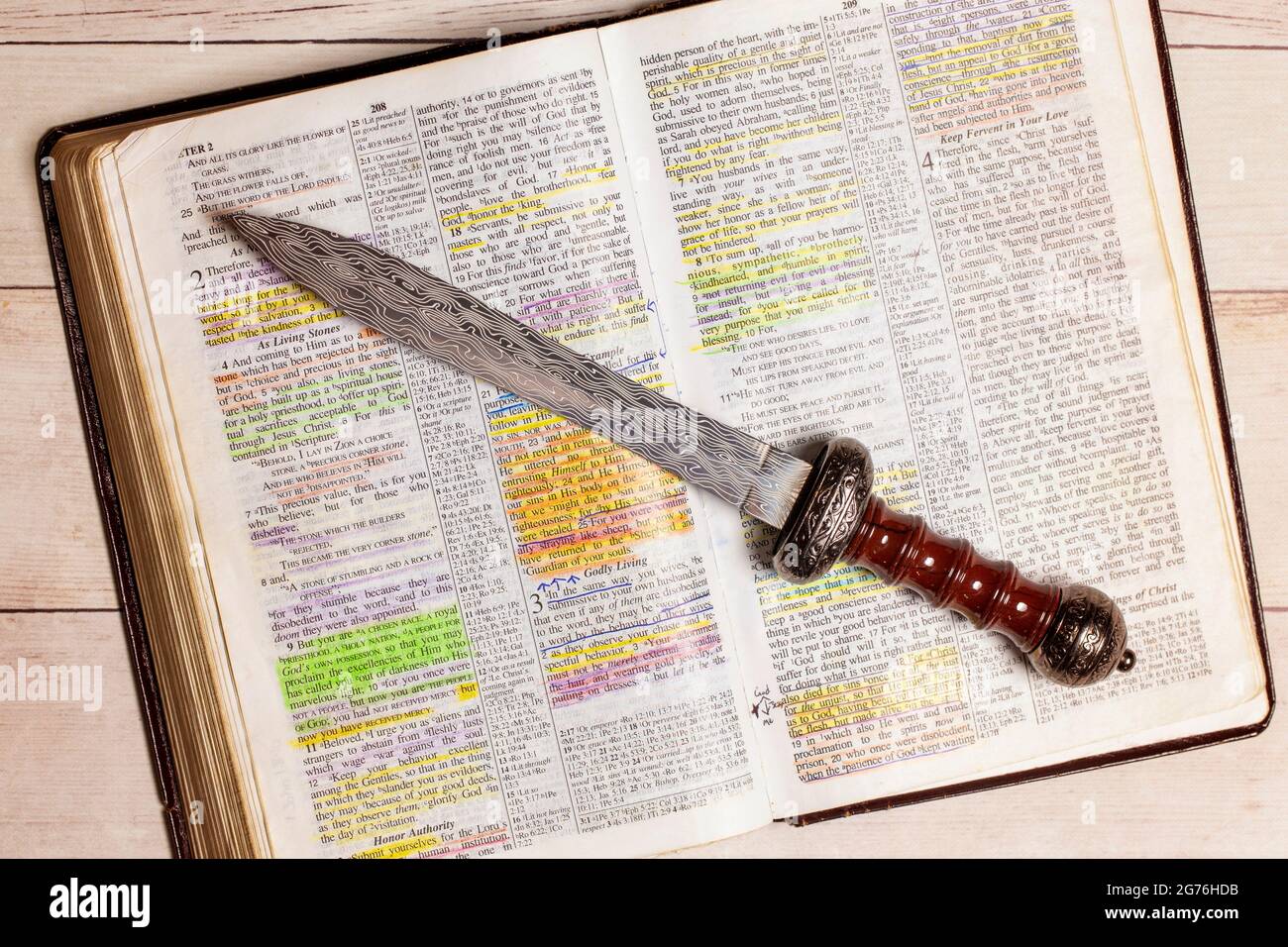 A Bible with a Sword on a Bright White Wooden Table Stock Photo - Alamy