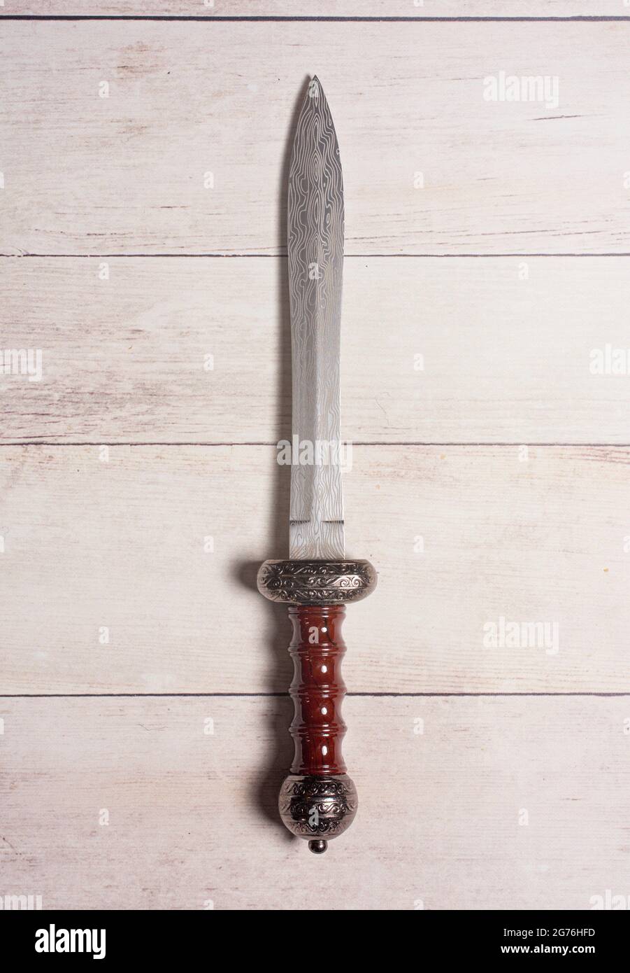 A Roman Gladius on a White Wooden Table Stock Photo - Alamy