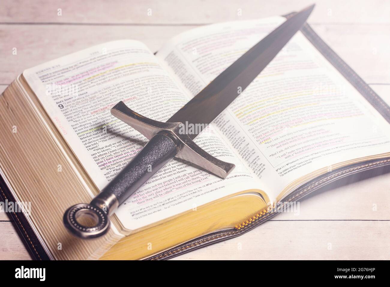 A Bible with a Sword on a Bright White Wooden Table Stock Photo - Alamy
