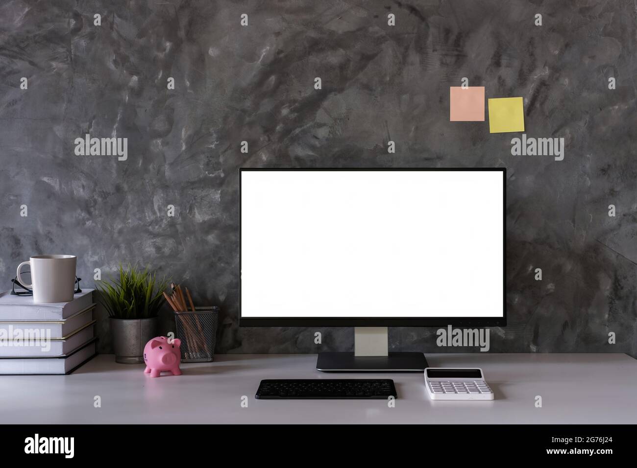 Front view of Mock up computer and office supplies gadget on desk ...