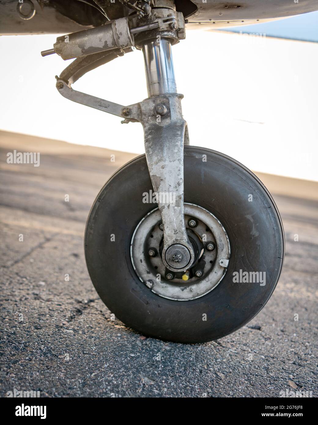 Front wheel of a small private plane on the ground Stock Photo - Alamy