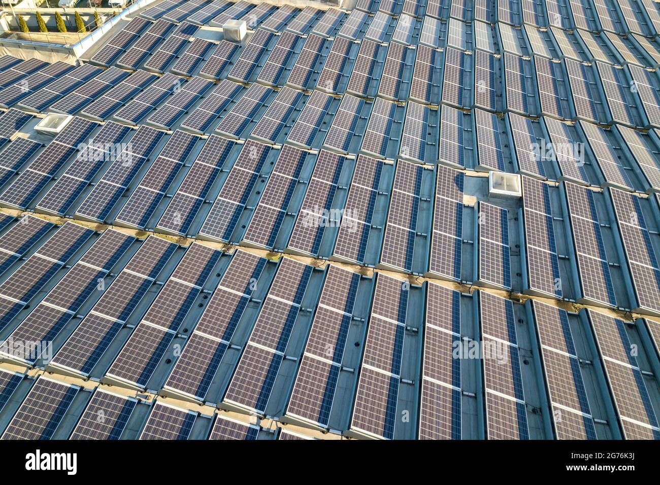 Aerial view of many photo voltaic solar panels mounted of industrial ...