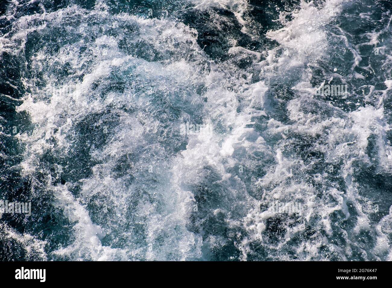 Top down aerial view of sea water surface. White foam waves texture as ...