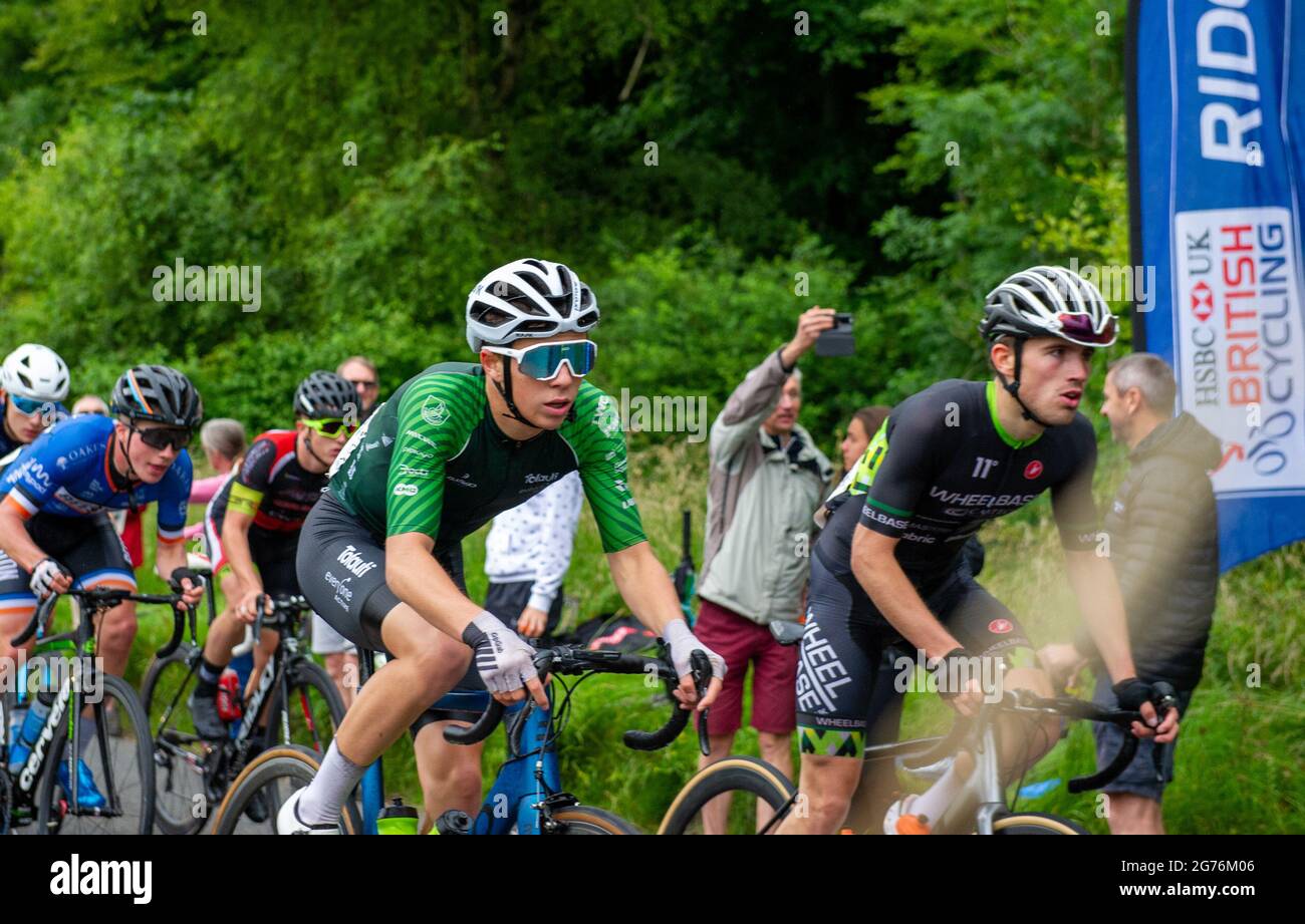 Pewsey, England. 11 July, 2021. The peloton pass through the feed zone ...