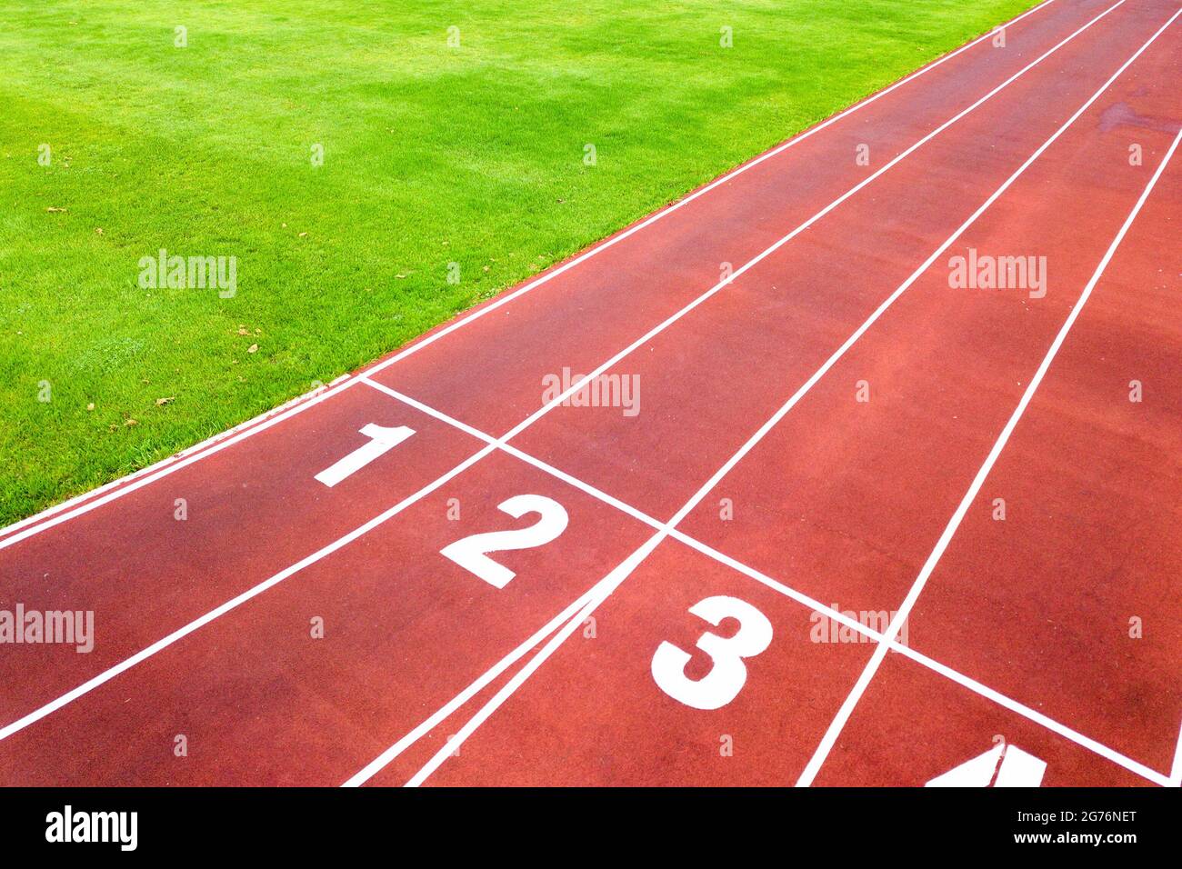 Aerial view of sports stadium with red running tracks with numbers on ...