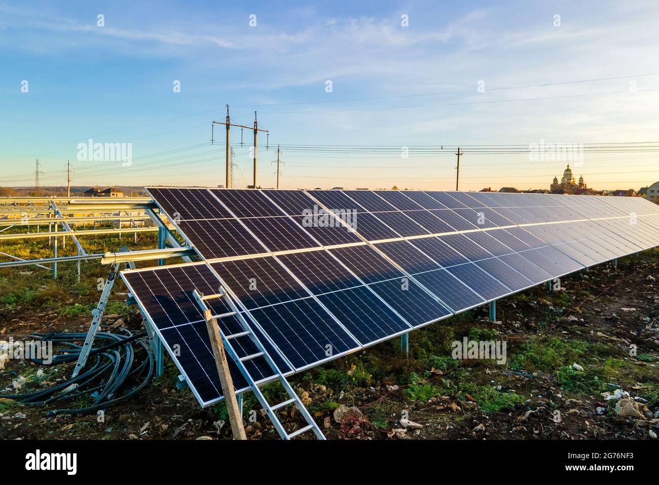 Solar power plant under construction on green field. Assembling of ...