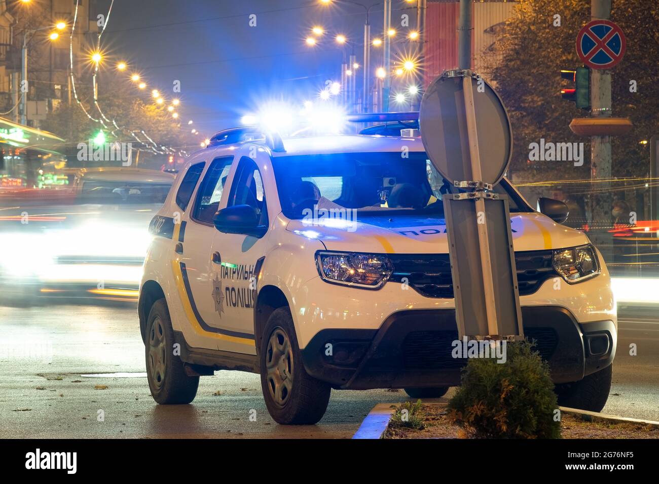 Bright flashing blue lights of police patrol car parked on city street ...