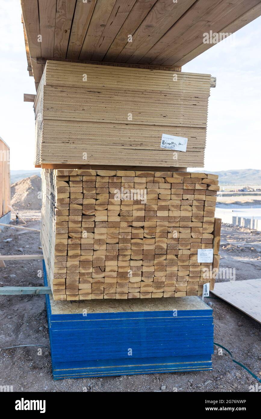 Four stacks of different sized lumber waiting to be used at a ...