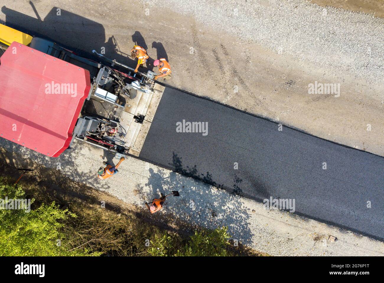Aerial view of new road construction with asphalt laying machinery at ...