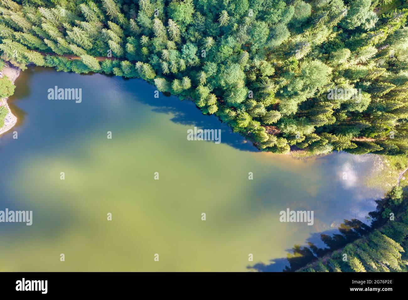 Top down aerial view of big lake with clear blue water between high ...