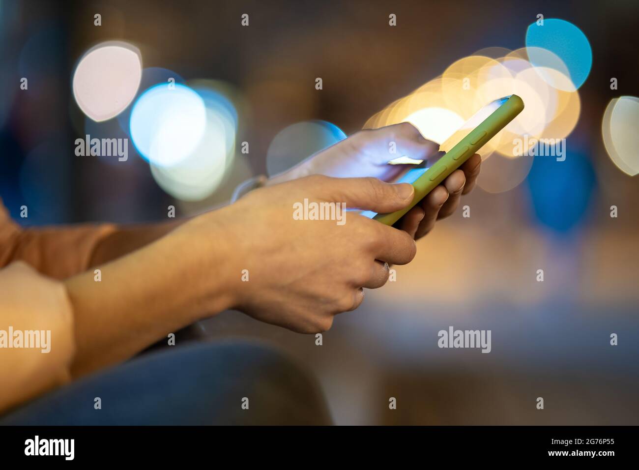 Closeup of female hands holding mobile phone browsing internet on city ...