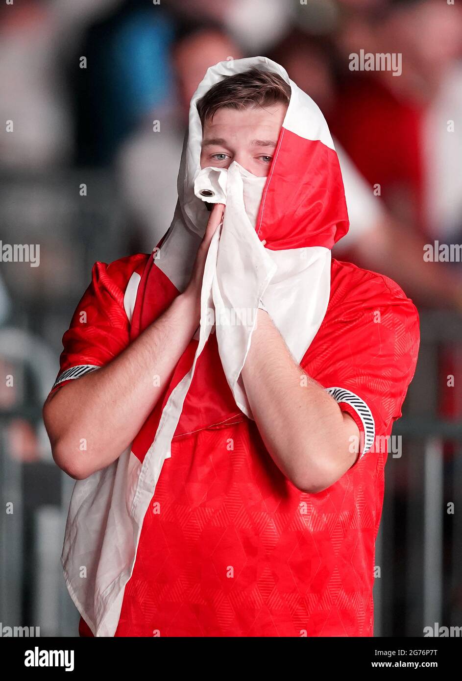 An England fan is dejected after England lose the game on penalties at ...