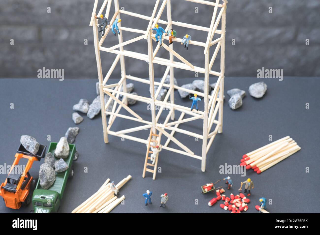 The miniature figures as workers team for building home Stock Photo - Alamy