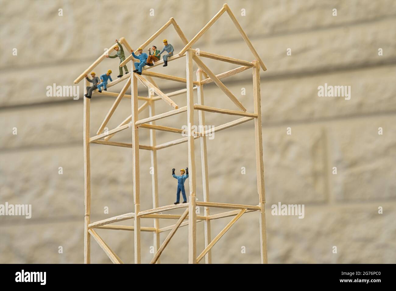 The miniature figures as workers team for building home Stock Photo - Alamy