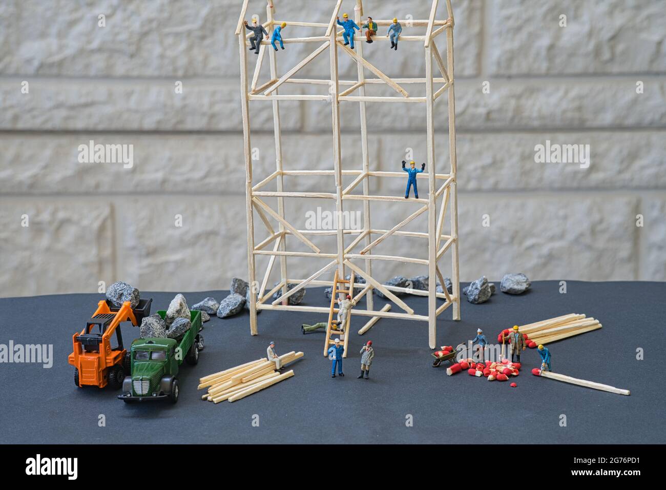 The miniature figures as workers team for building home Stock Photo - Alamy