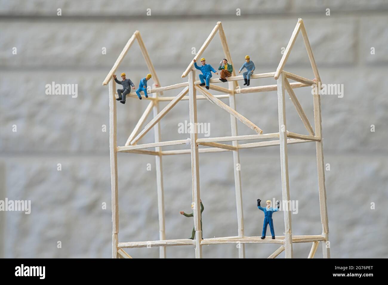 The miniature figures as workers team for building home Stock Photo - Alamy