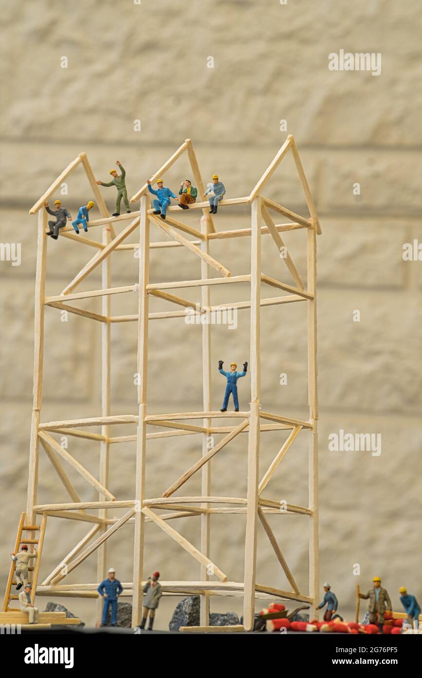Team building miniature construction workers hi-res stock photography ...