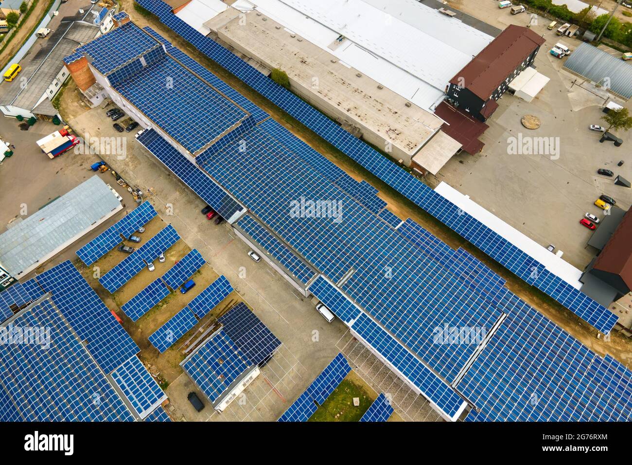 Aerial view of blue photovoltaic solar panels mounted on industrial ...
