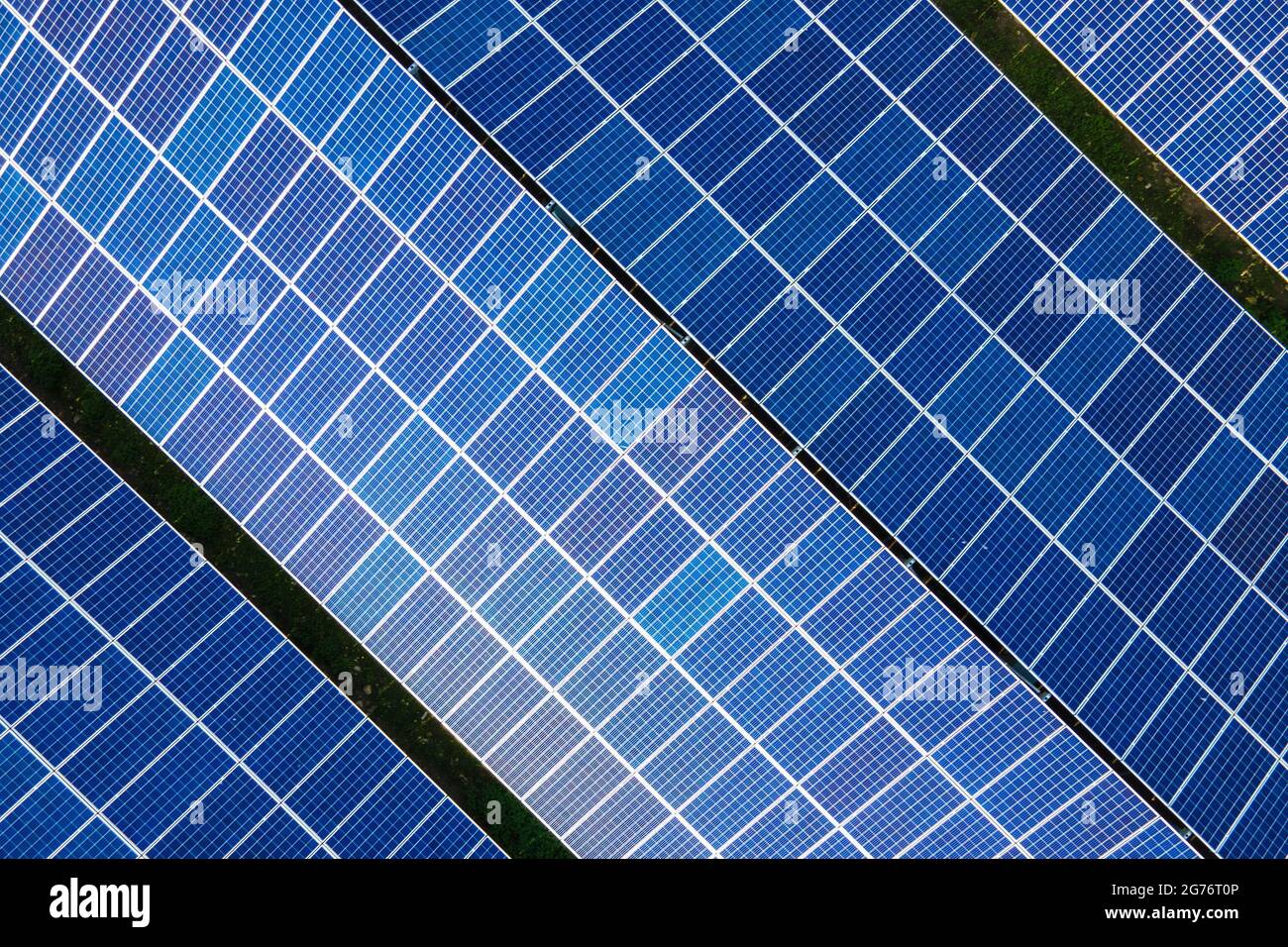 Aerial view building roof with rows of solar photovoltaic panels for ...
