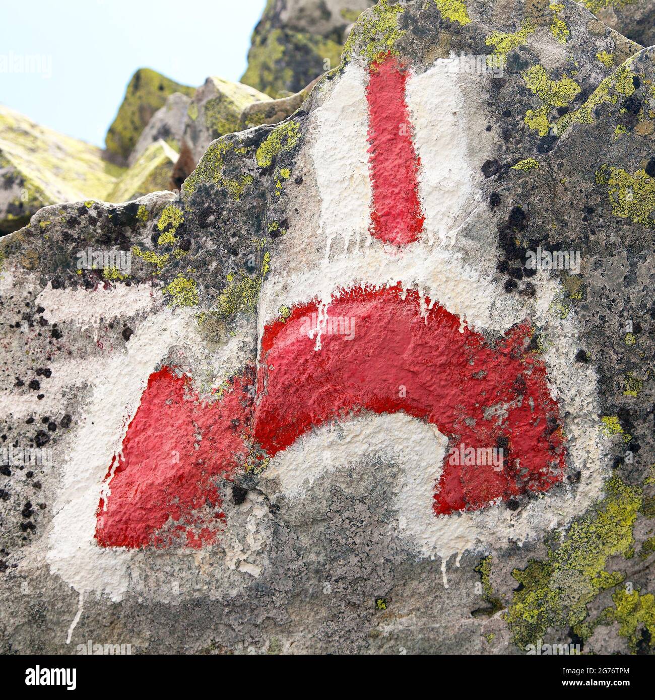 red and white hiking trail signs symbols in Italy alps on grey stone ...
