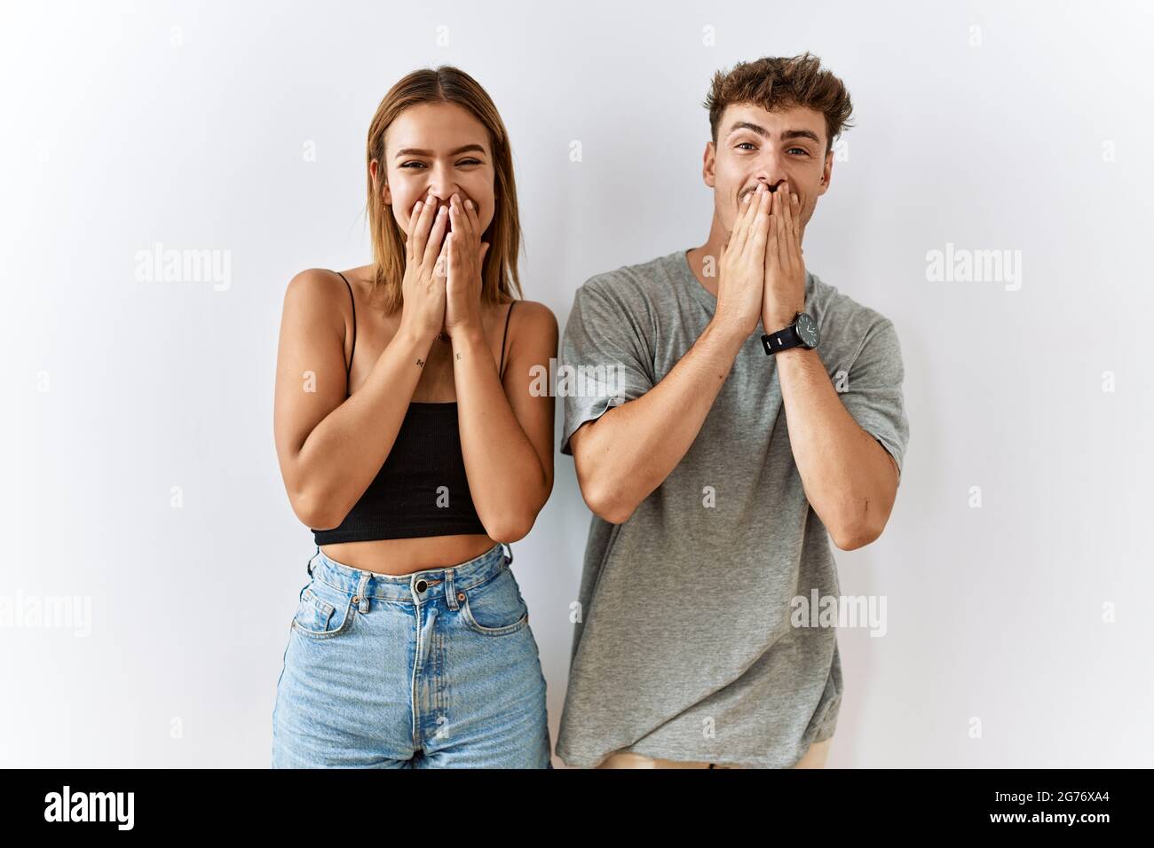 Young beautiful couple standing together over isolated background ...