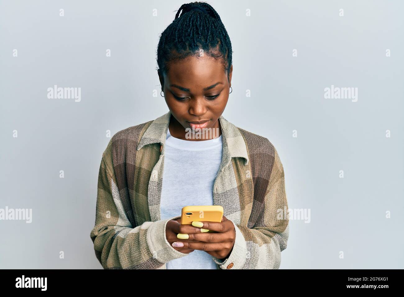 Young african american woman using smartphone depressed and worry for ...