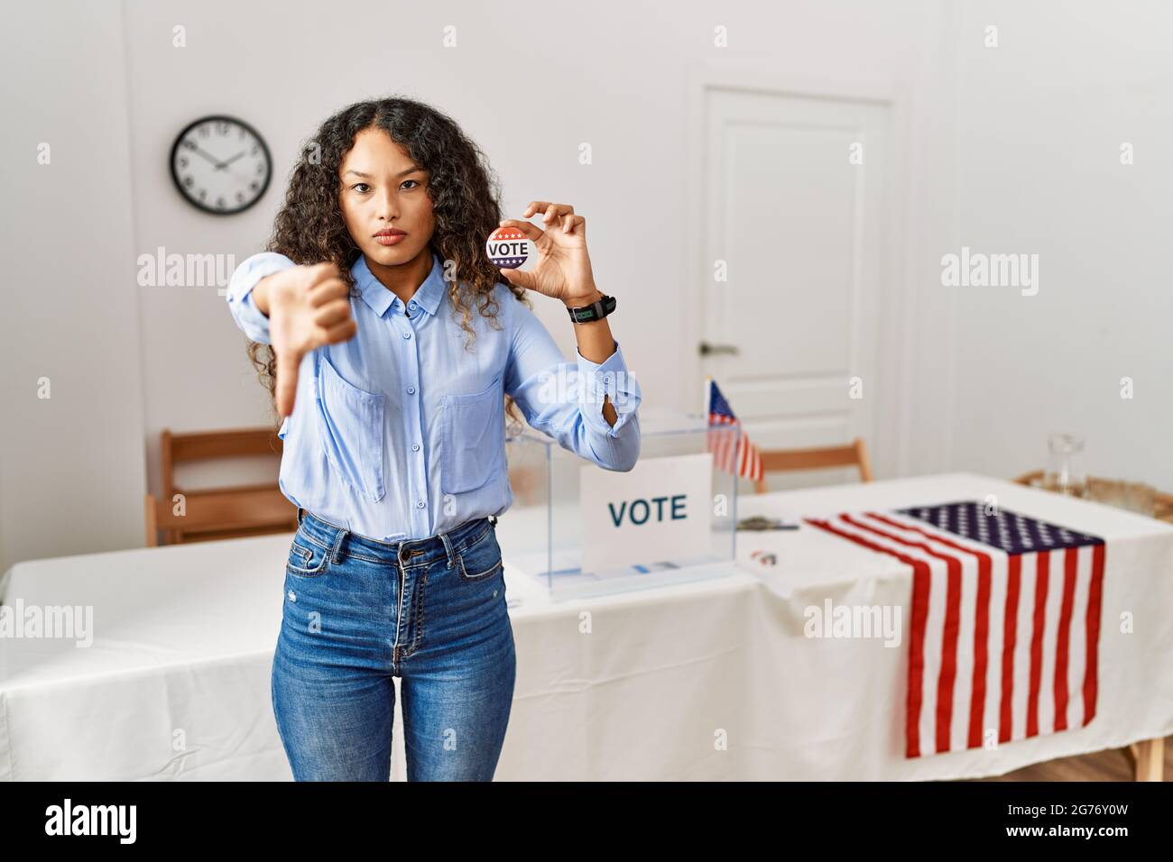 Beautiful hispanic woman standing by at political campaign by voting ...