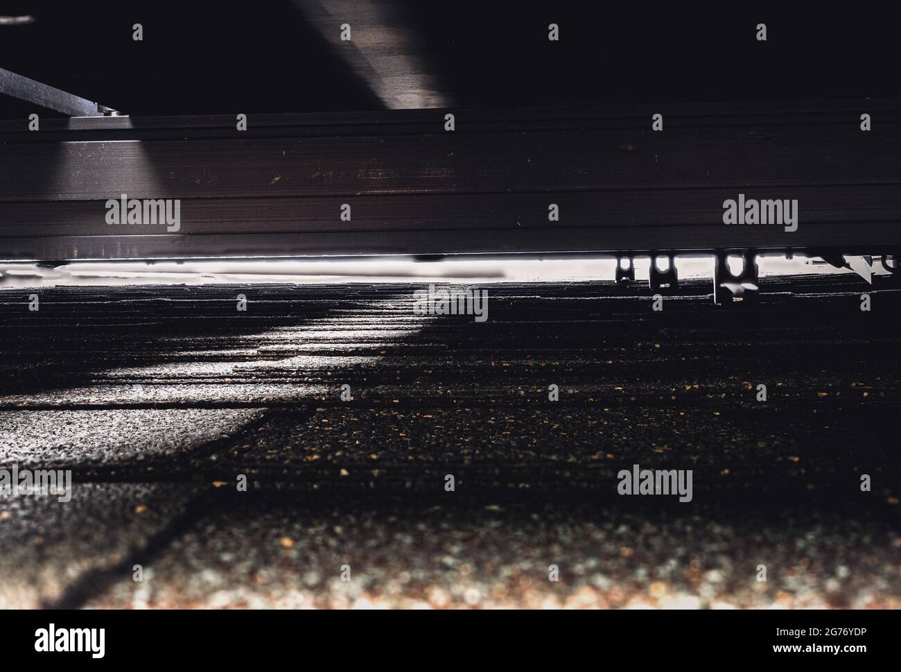 Gap underneath solar panels and asphalt shingle roof with rails and ...