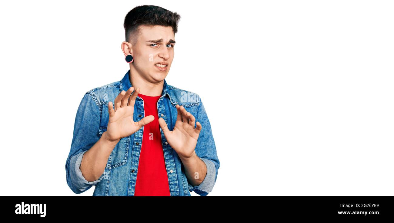 Young caucasian boy with ears dilation wearing casual denim jacket ...