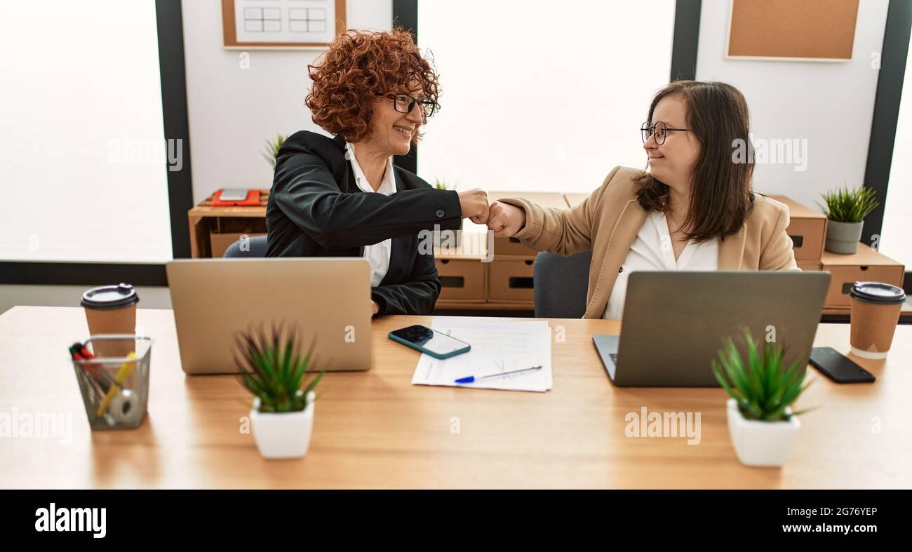 Group of two women working at the office. Mature woman and down ...