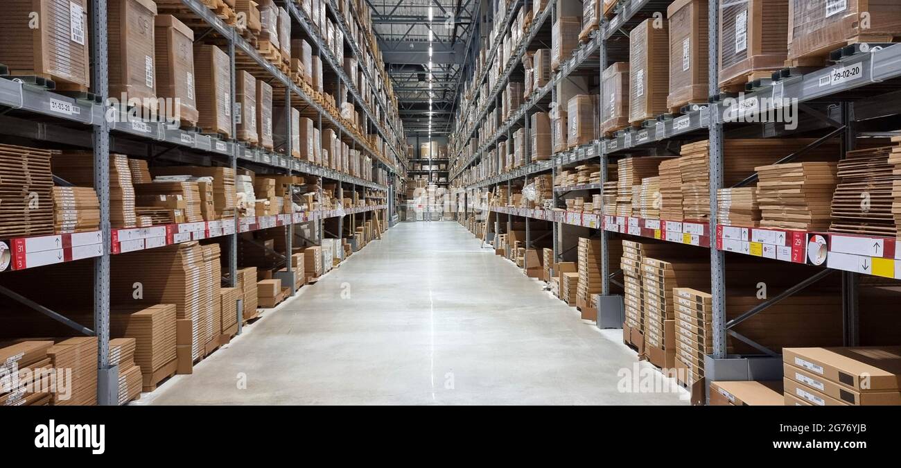 A row of warehouse shelves full of packaged goods in boxes Stock Photo ...